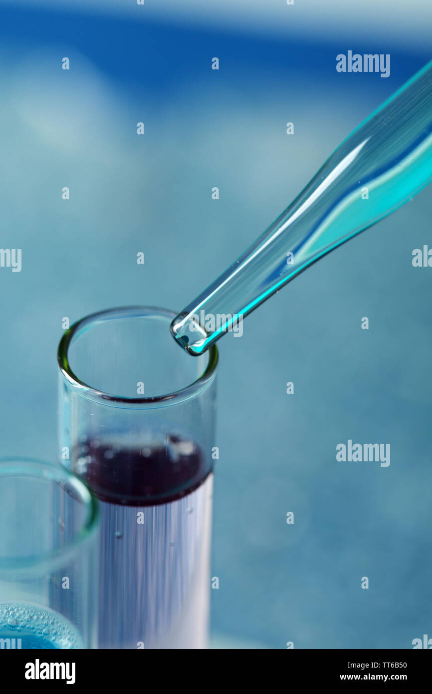 Test-tubes with liquid on color background. Drops from test stick Stock ...