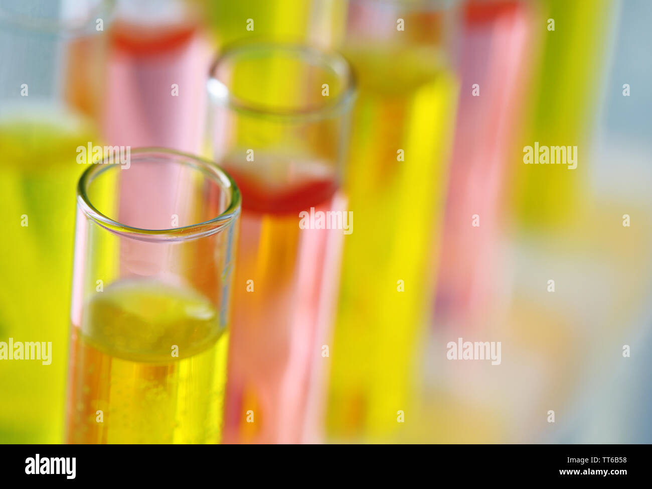 Test-tubes with liquid on color background Stock Photo - Alamy