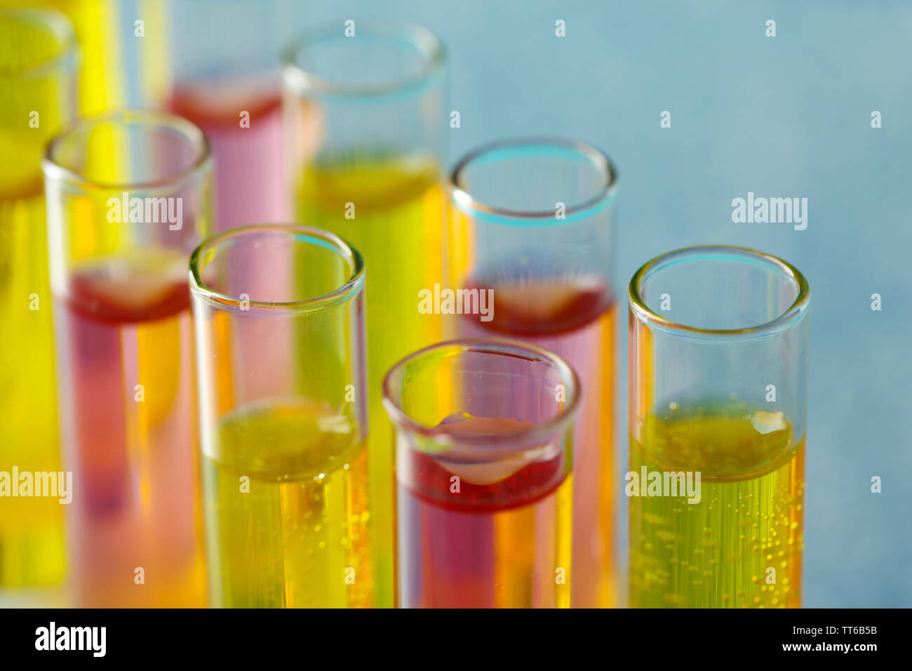 Test-tubes with liquid on color background Stock Photo - Alamy