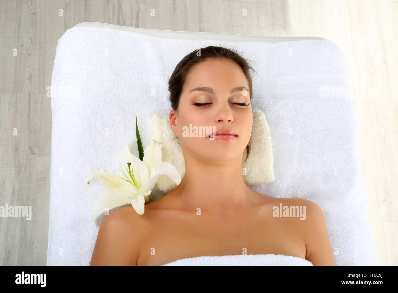 Beautiful young woman in spa salon on light background Stock Photo - Alamy