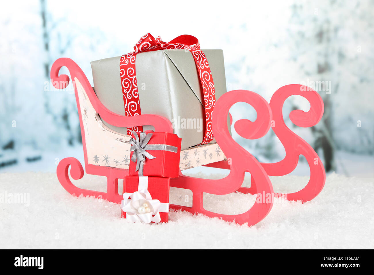 Wooden toy sledge with Christmas gifts on nature background Stock Photo ...