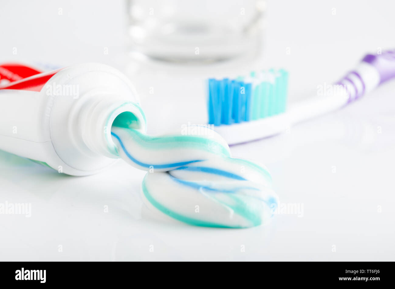 Toothbrush, tube of toothpaste and a glass on a white background Stock ...