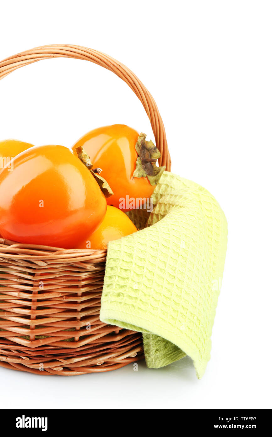 Ripe persimmons in wicker basket isolated on white Stock Photo - Alamy