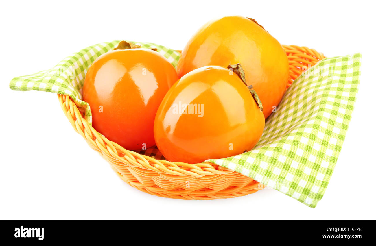 Ripe persimmons in wicker basket isolated on white Stock Photo - Alamy