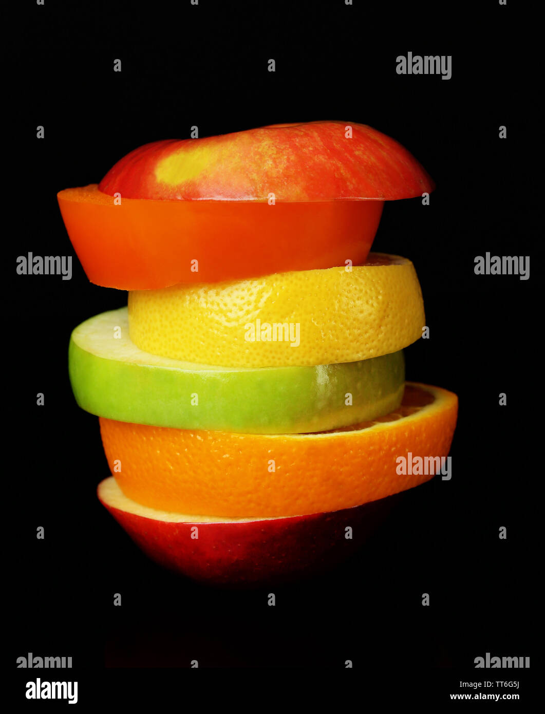 Fresh sliced fruit isolated on black Stock Photo - Alamy