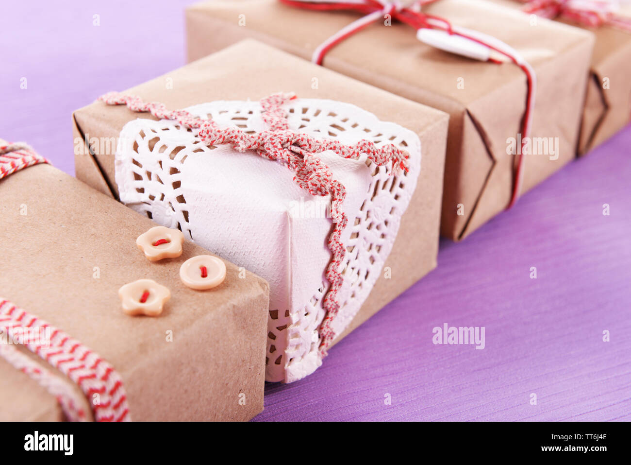 Group of handmade present boxes on purple background Stock Photo - Alamy