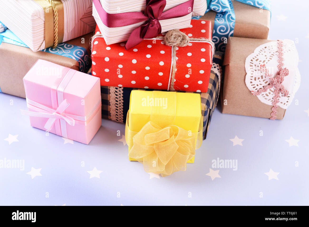 Pile of colorful gifts on blue background with stars Stock Photo - Alamy
