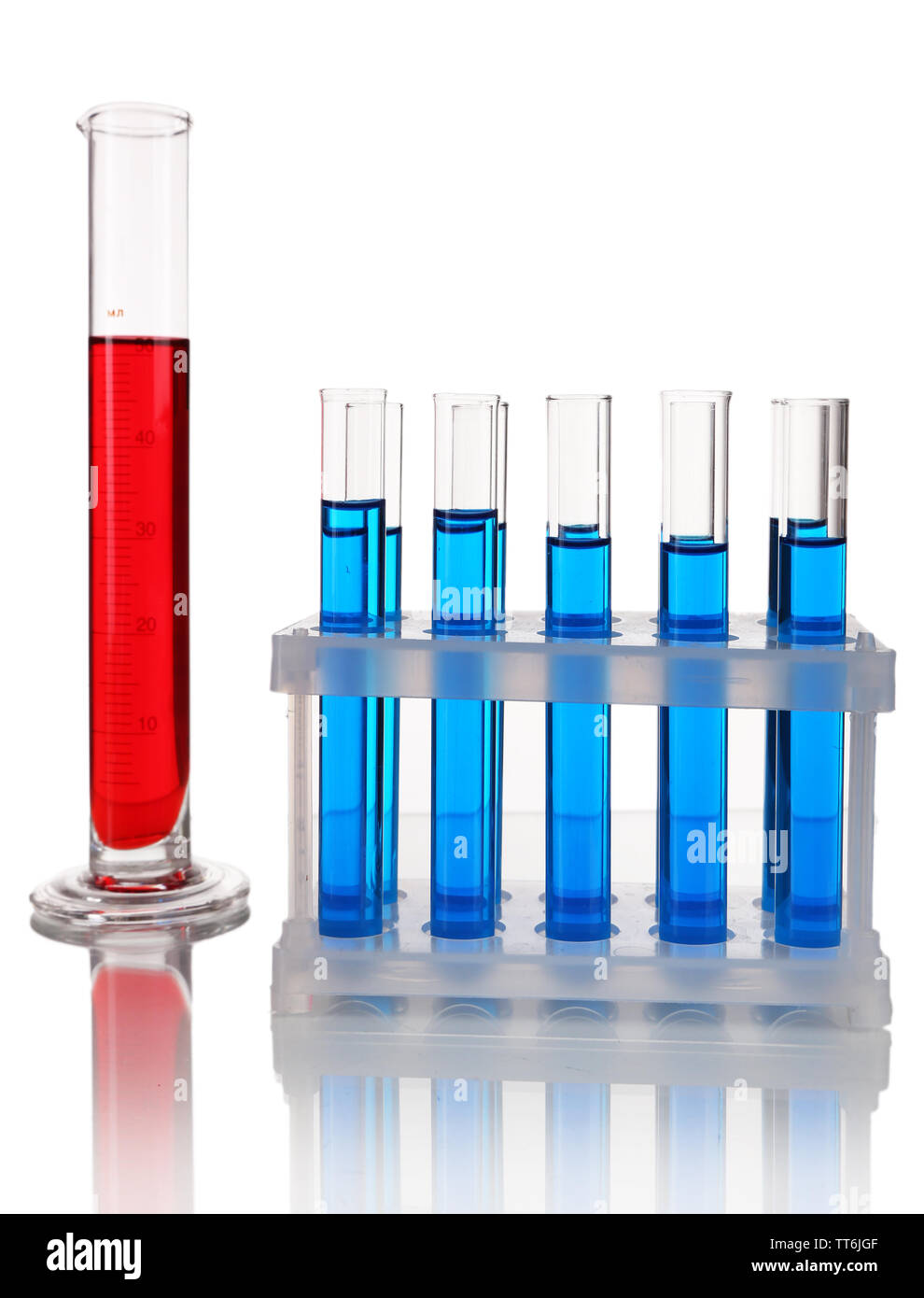 Test-tubes in container with blue and red fluid on light background ...