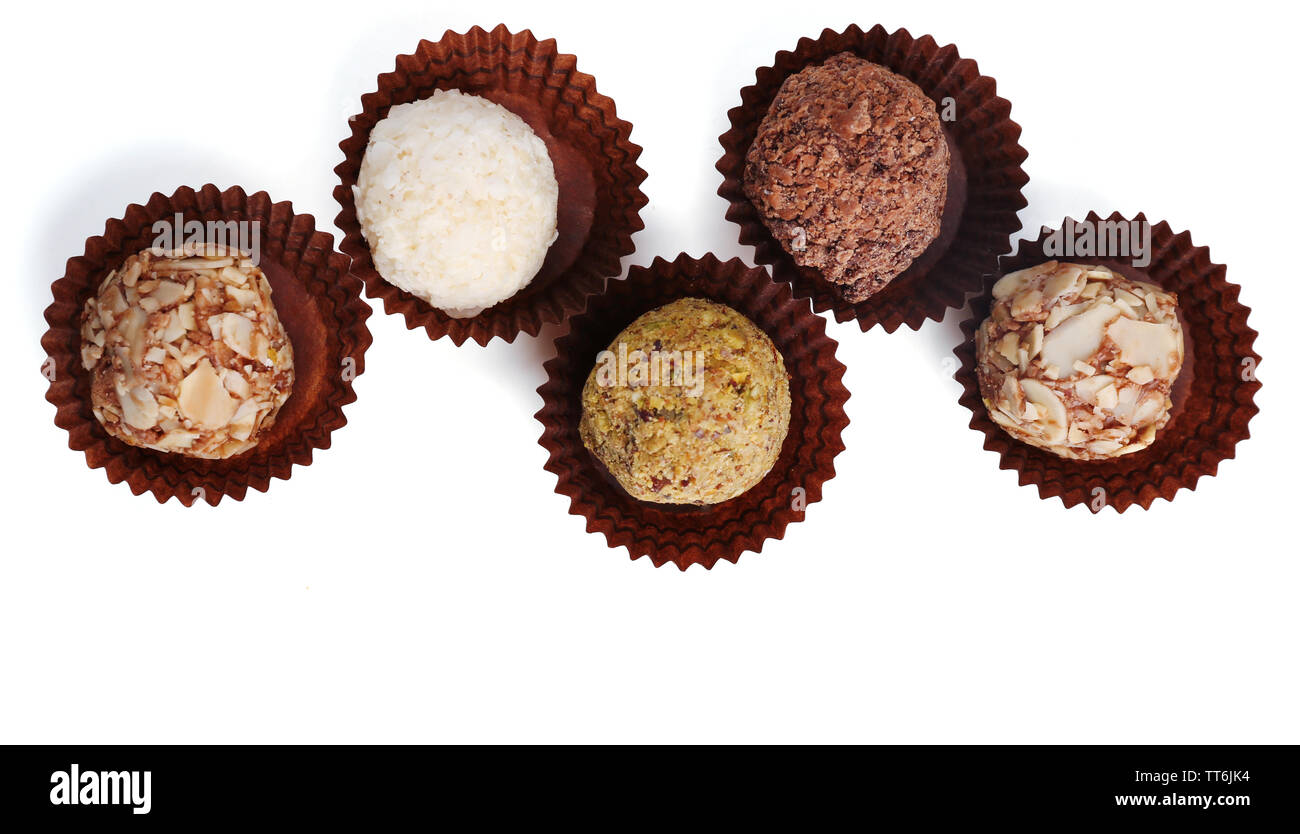 Zigzag of round chocolates wrapped in paper bowl on white background ...