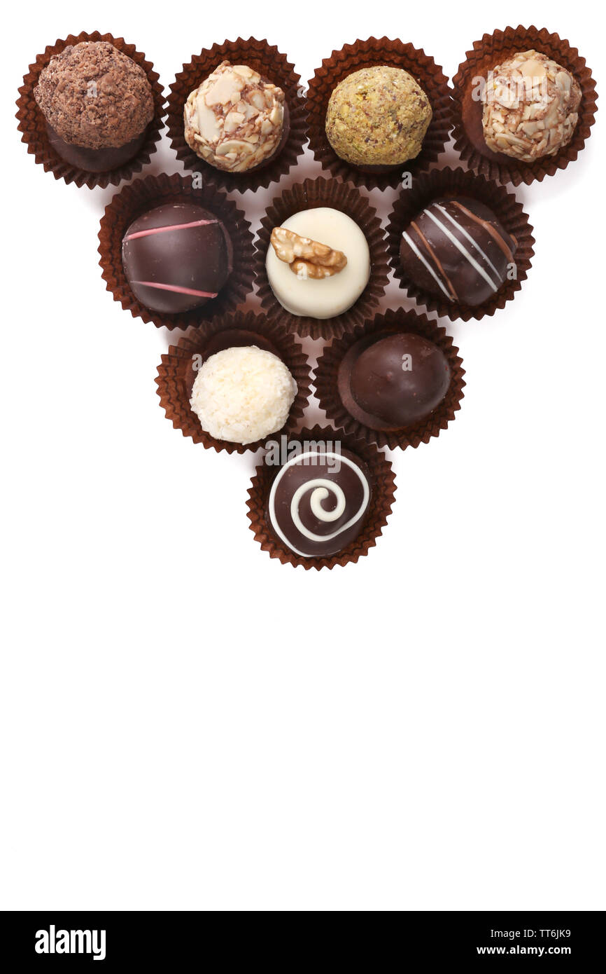 Group of round chocolates in paper bowls isolated on white background ...