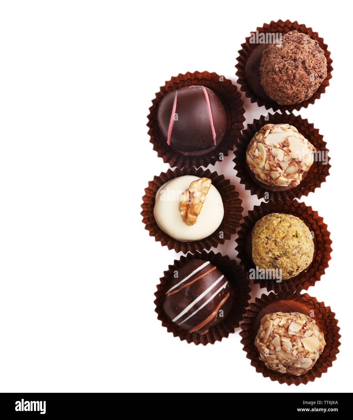 Group of round chocolates in paper bowls isolated on white background ...