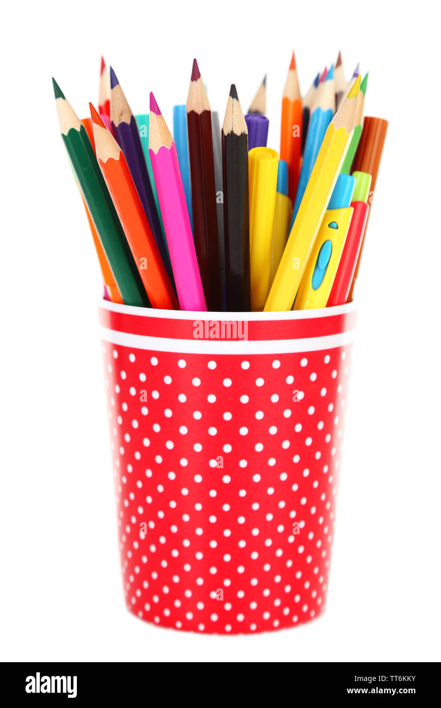 Colorful pens, pencils and markers in red polka-dot plastic cup ...