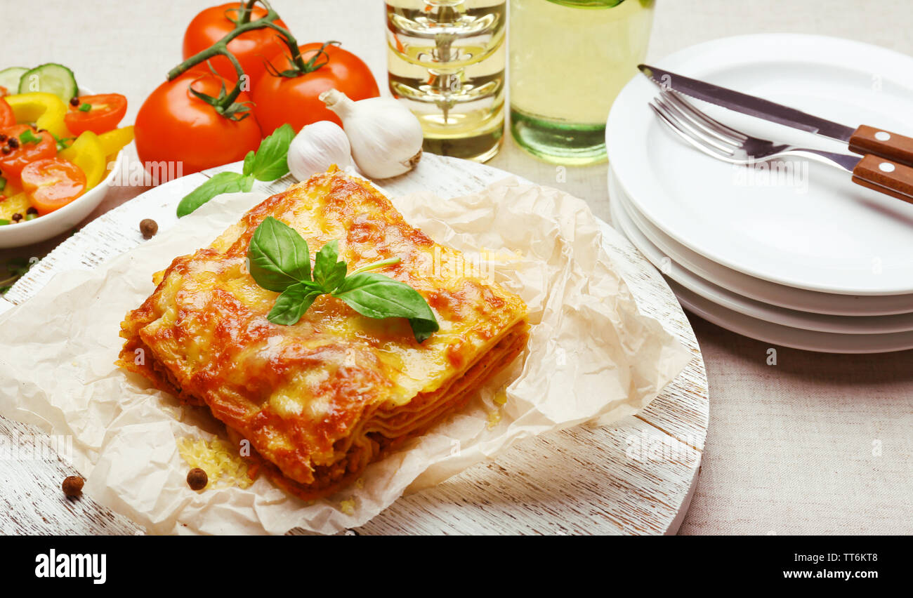 Portion of tasty lasagna on table Stock Photo - Alamy