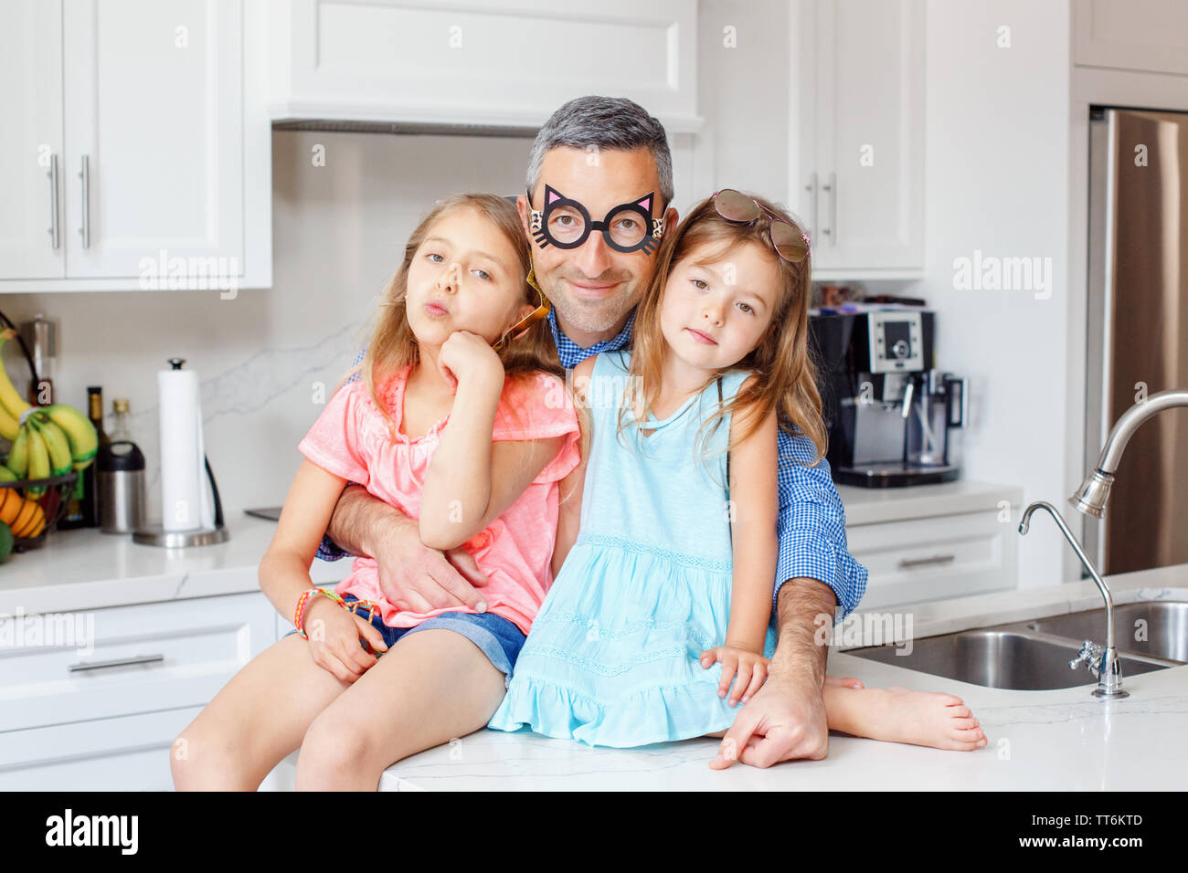 Caucasian father dad wearing funny glasses hugging embracing two ...
