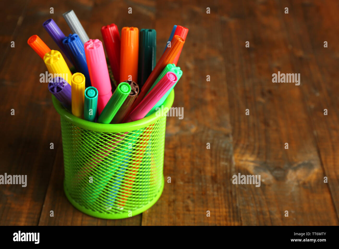 Colorful markers in metal holder on rustic wooden background Stock ...