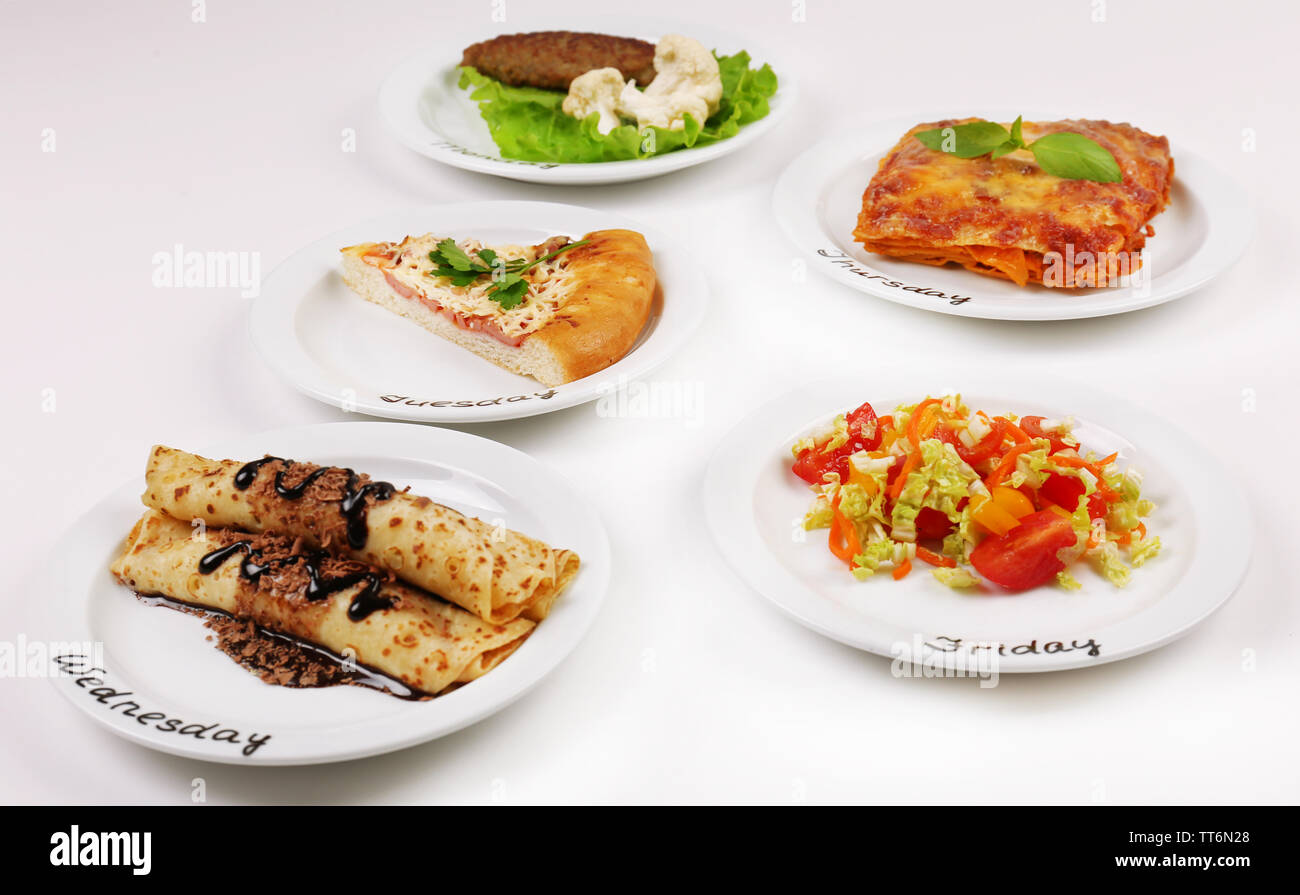 Daily menu. Plates with food on table Stock Photo - Alamy