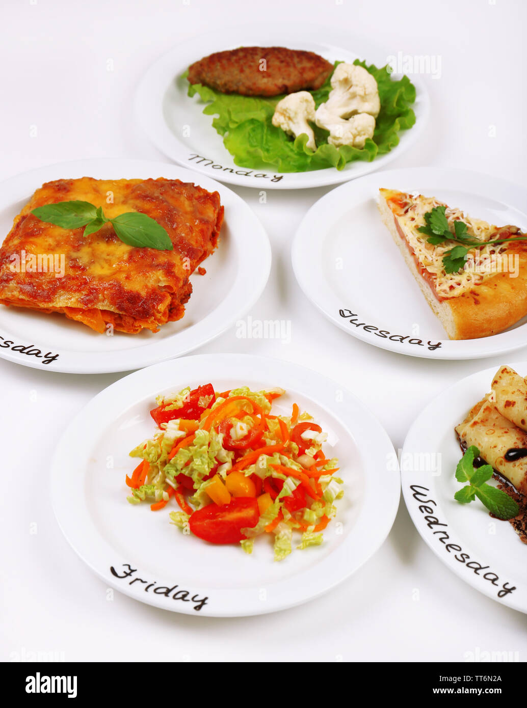 Daily menu. Plates with food on table Stock Photo - Alamy
