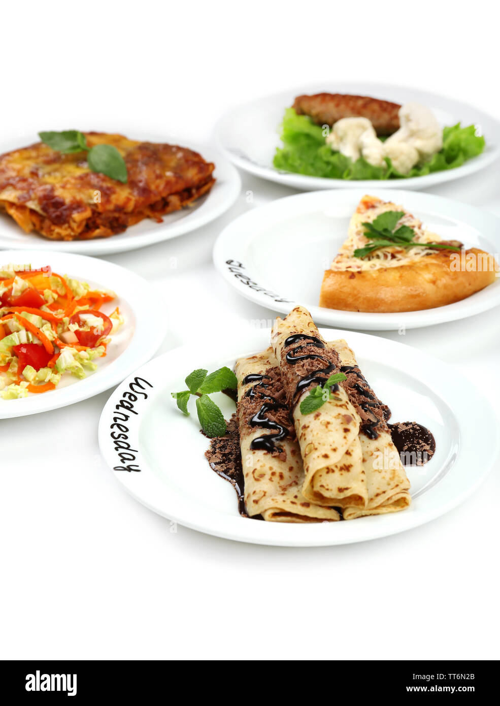 Daily menu. Plates with food on table Stock Photo - Alamy