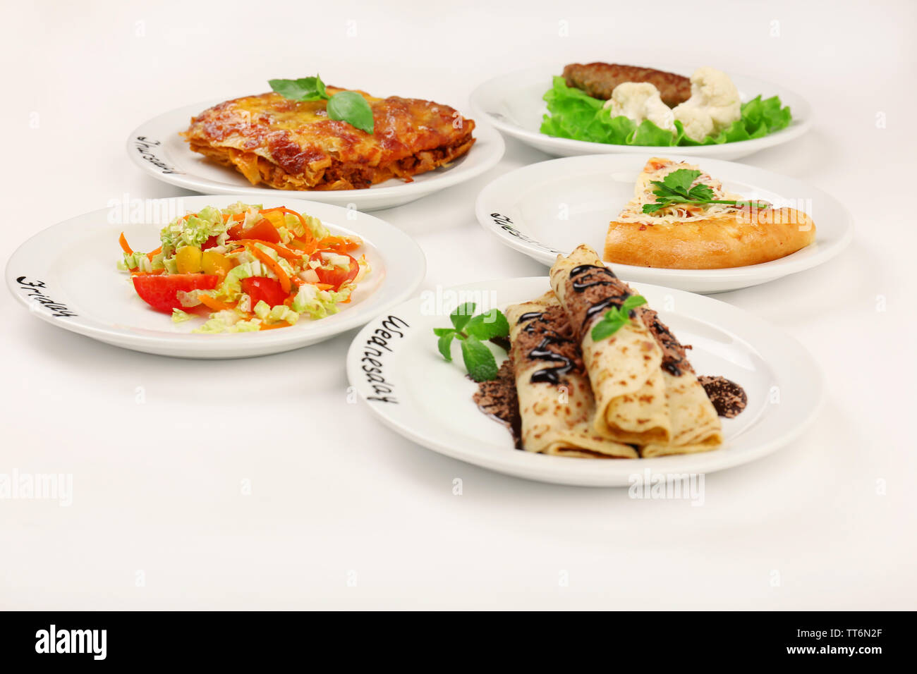 Daily menu. Plates with food on table Stock Photo - Alamy