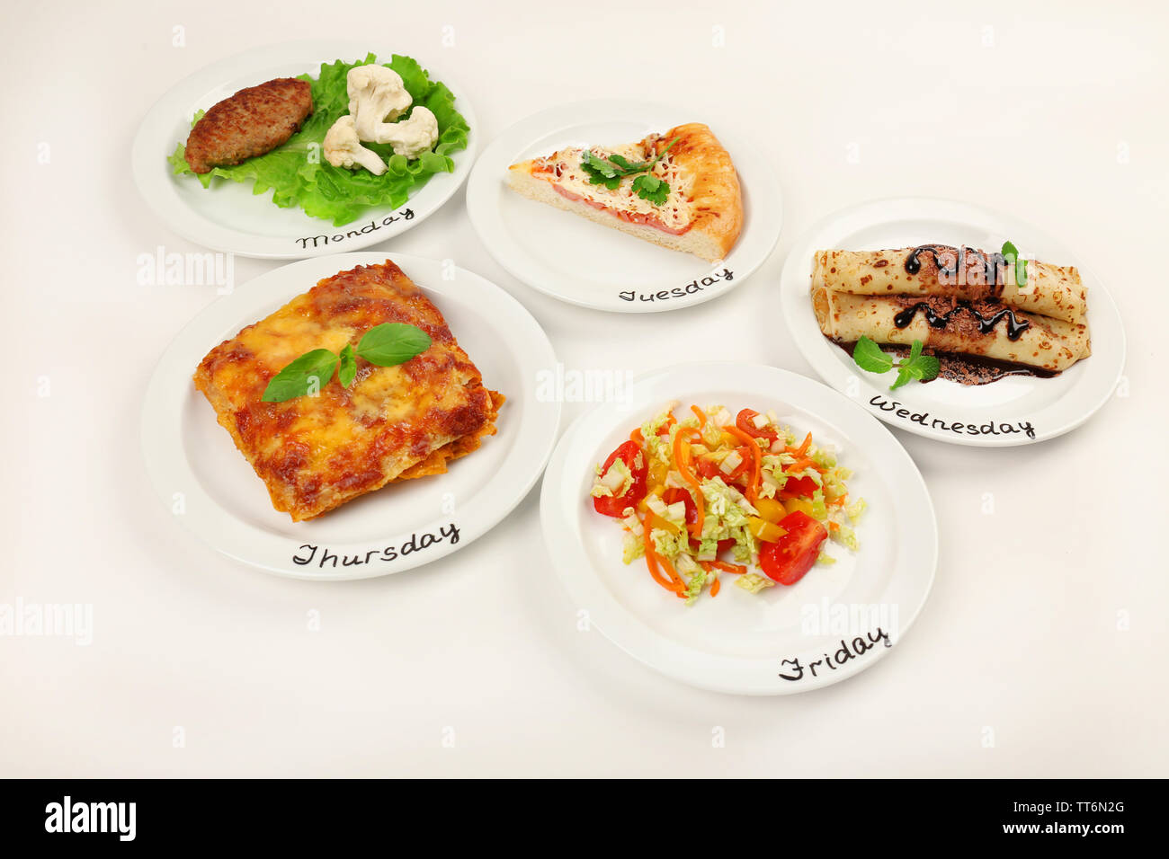 Daily menu. Plates with food on table Stock Photo - Alamy