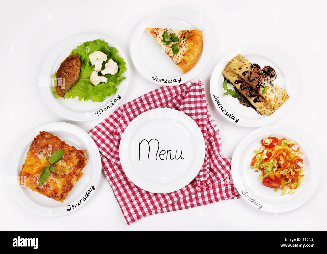 Daily menu. Plates with food on table Stock Photo - Alamy