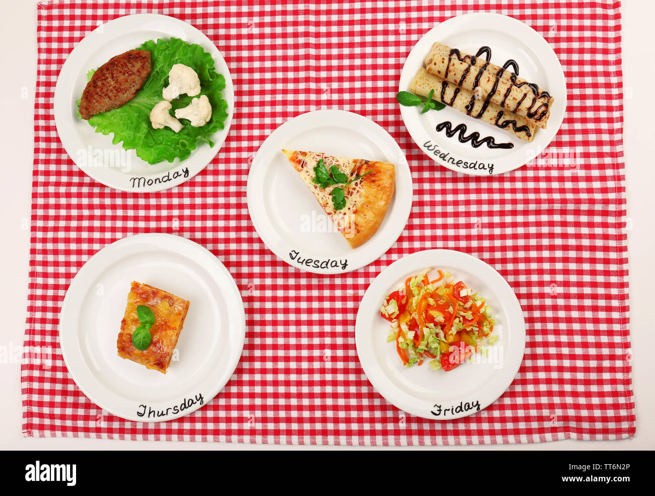Daily menu. Plates with food on table Stock Photo - Alamy