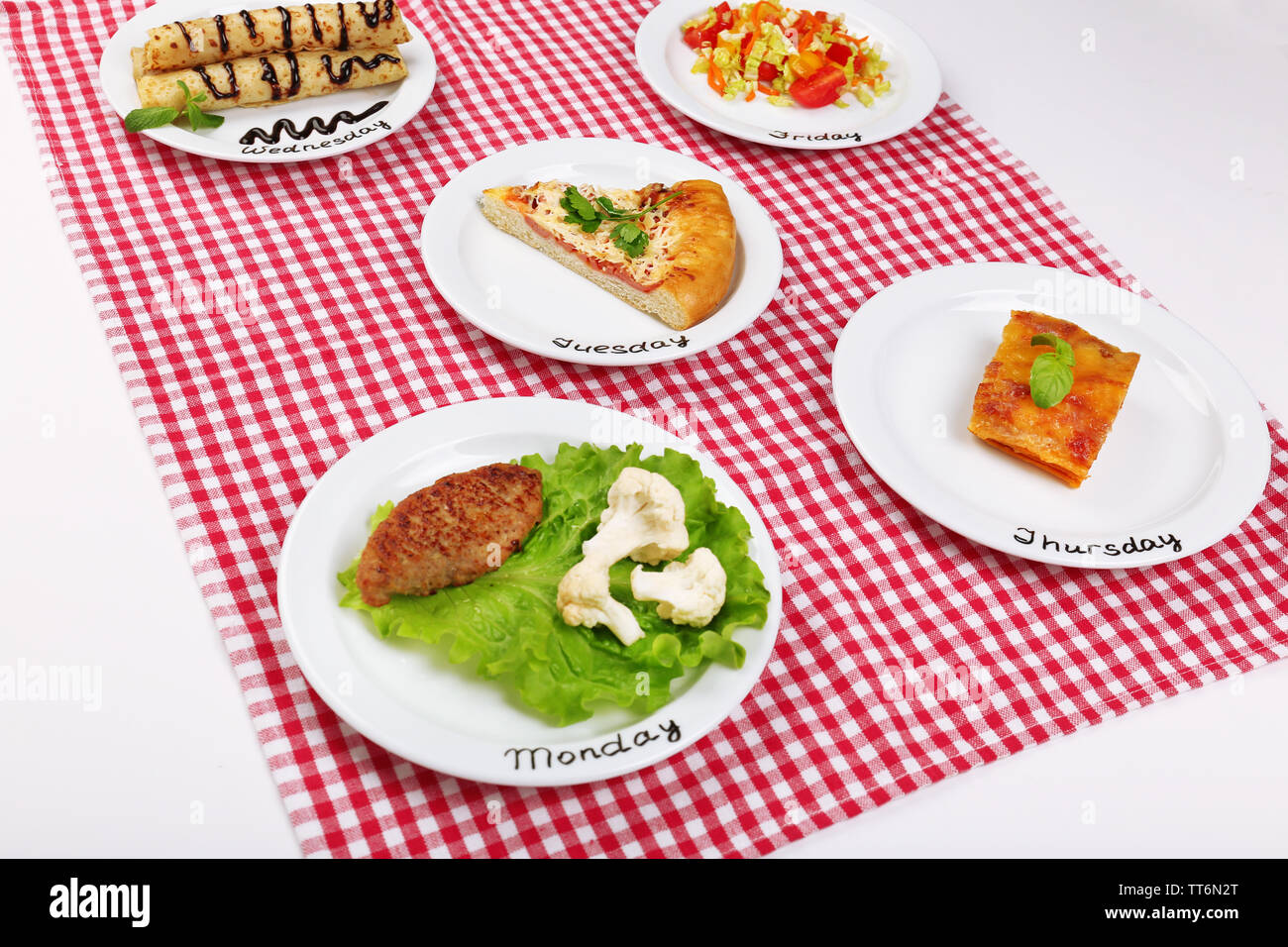 Daily menu. Plates with food on table Stock Photo - Alamy