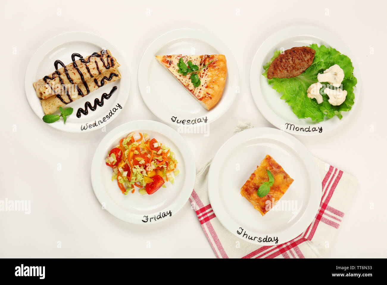 Daily menu. Plates with food on table Stock Photo - Alamy