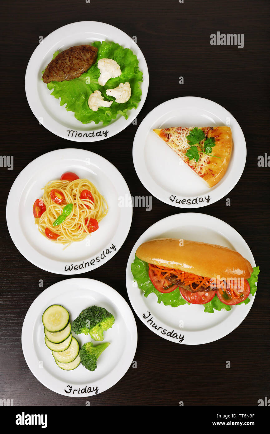 Daily menu. Plates with food on table Stock Photo - Alamy