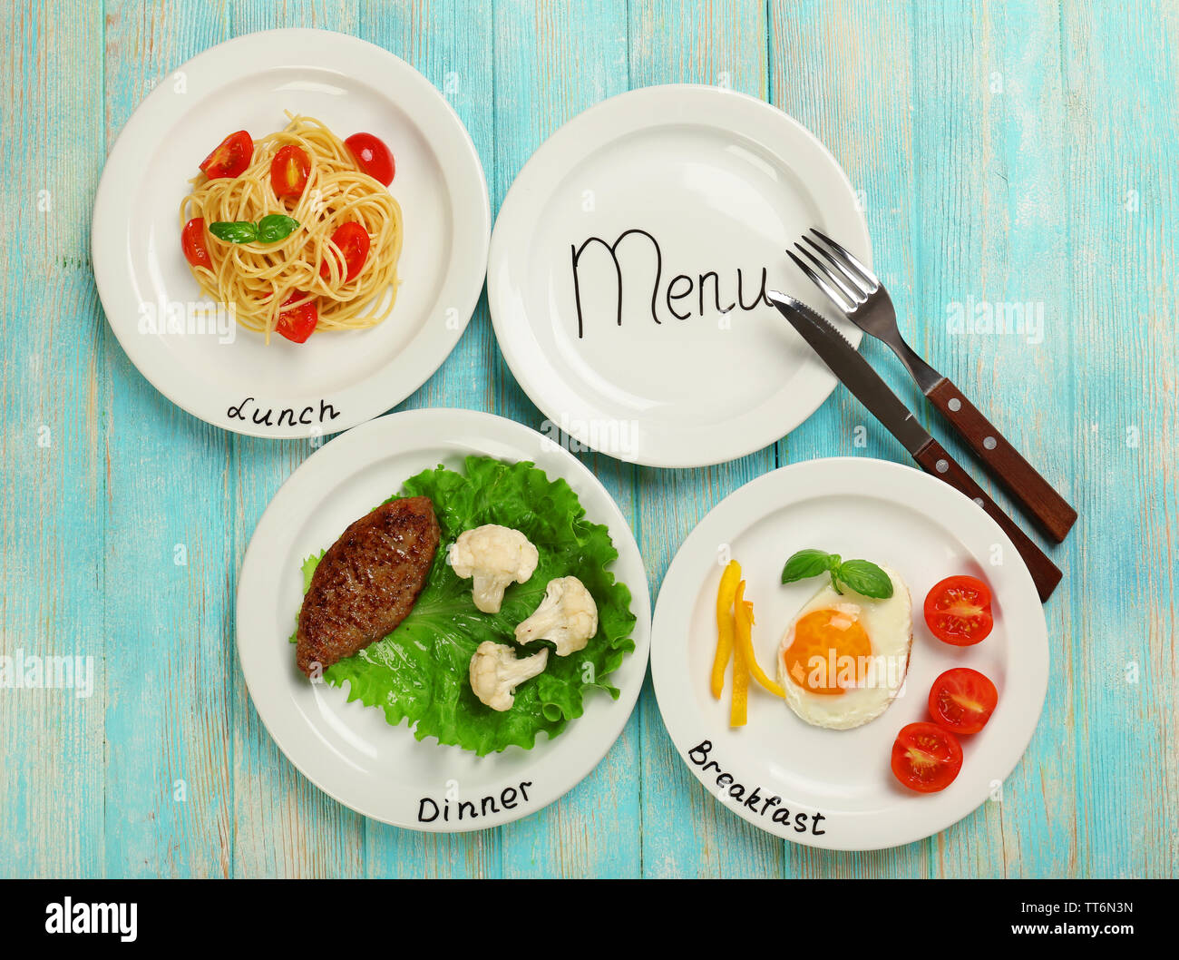 Menu of day. Plates with food on table Stock Photo - Alamy