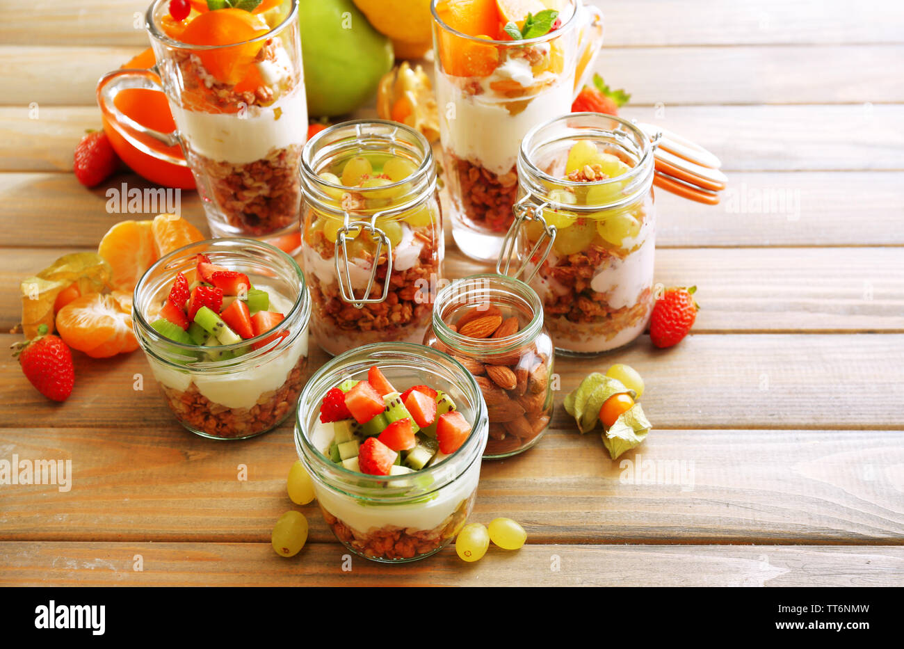Healthy layered desserts with muesli and fruits on table Stock Photo ...
