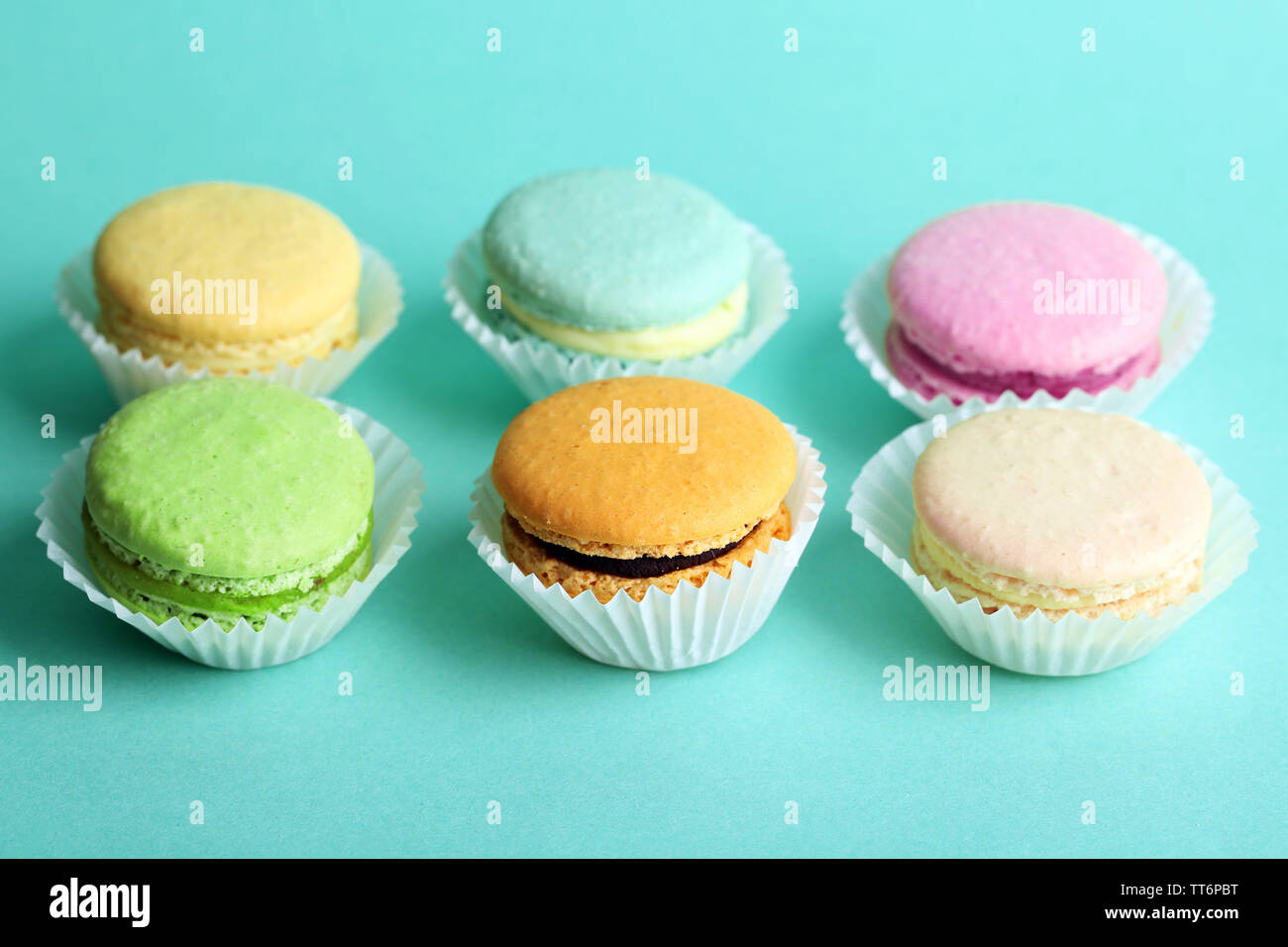Set of gentle colorful macaroons on color background Stock Photo - Alamy