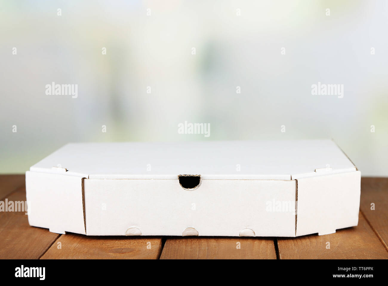Empty cardboard pizza box on wooden table, on light background Stock ...
