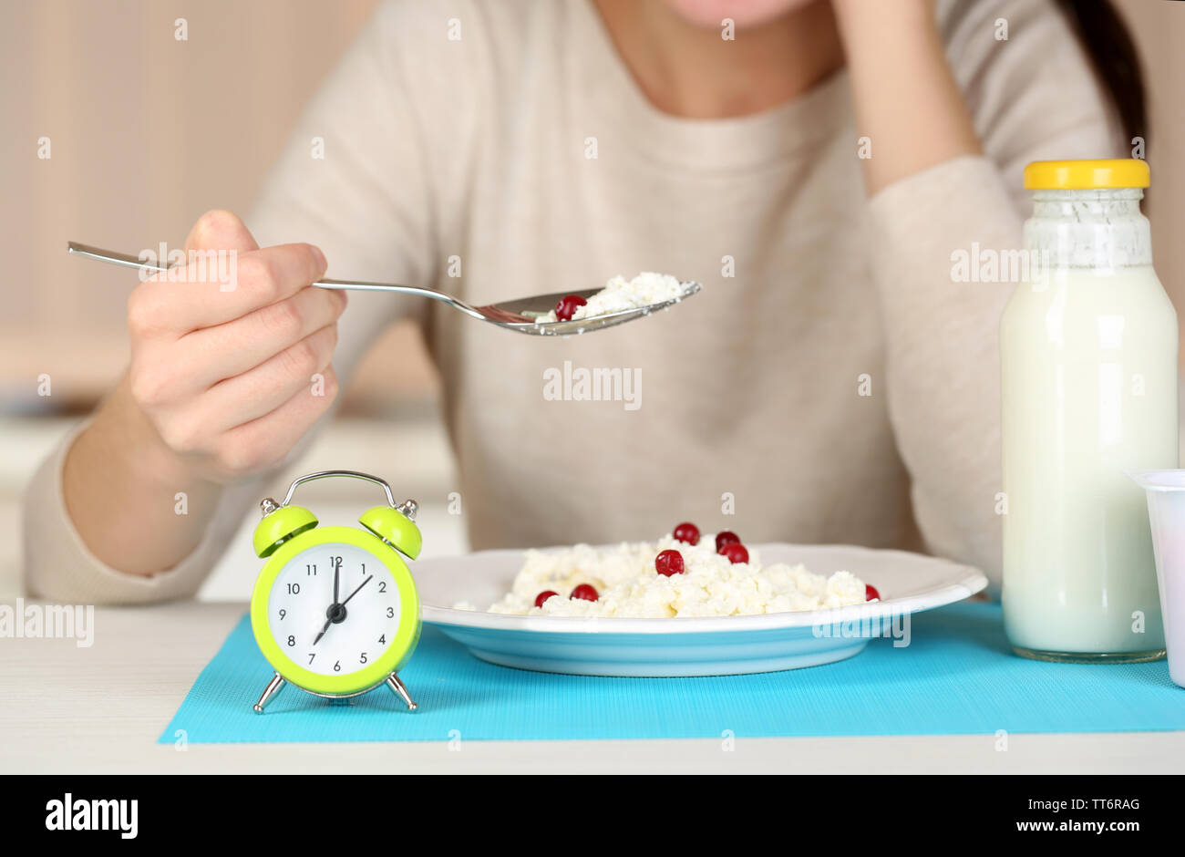 Girl eating diet food at table close-up Stock Photo - Alamy