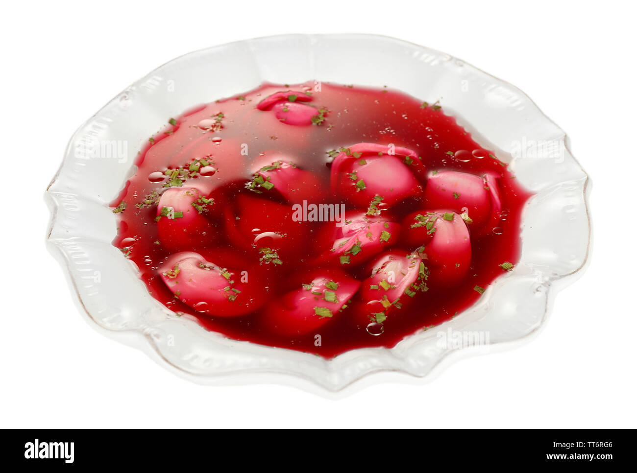 Traditional polish clear red borscht with dumplings isolated on white ...