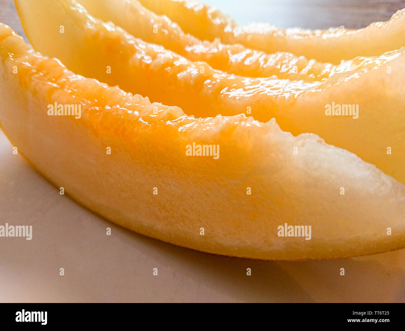 Delicious honey melon pieces as background, soft focus Stock Photo - Alamy