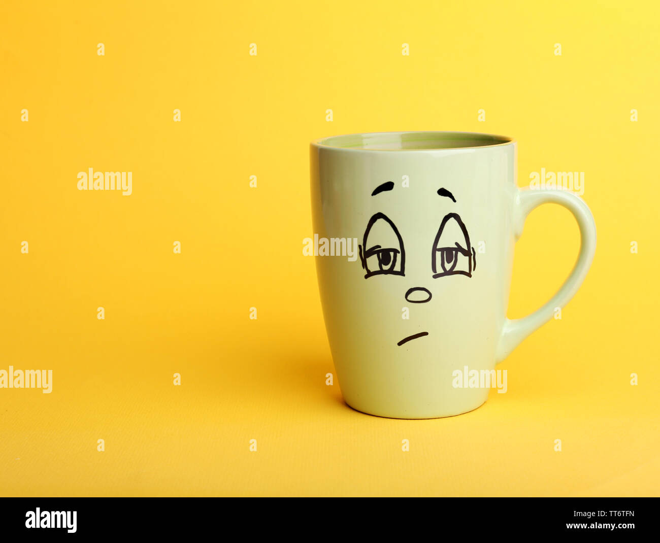 Emotional cup on yellow background Stock Photo - Alamy