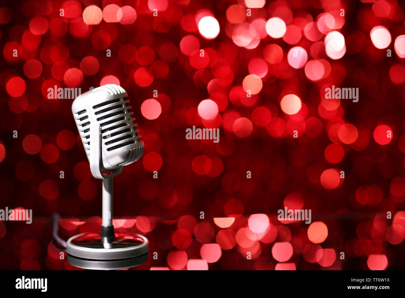 Silver microphone on red background Stock Photo - Alamy