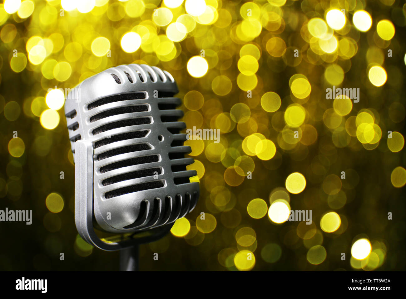 Silver microphone on golden background Stock Photo - Alamy