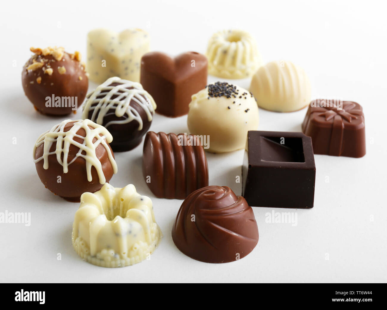 Delicious chocolate candies isolated on white Stock Photo - Alamy