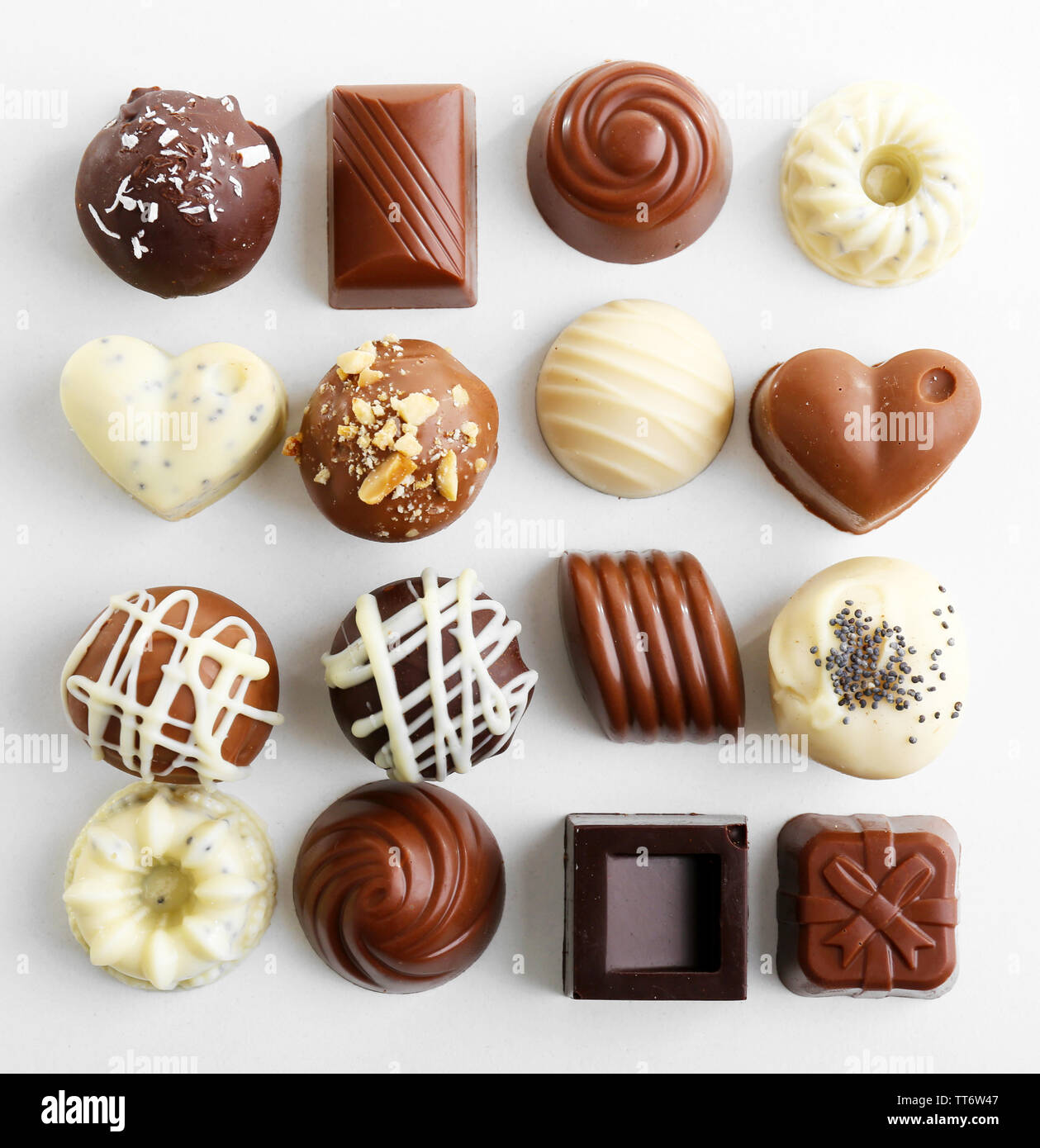 Delicious chocolate candies isolated on white Stock Photo - Alamy
