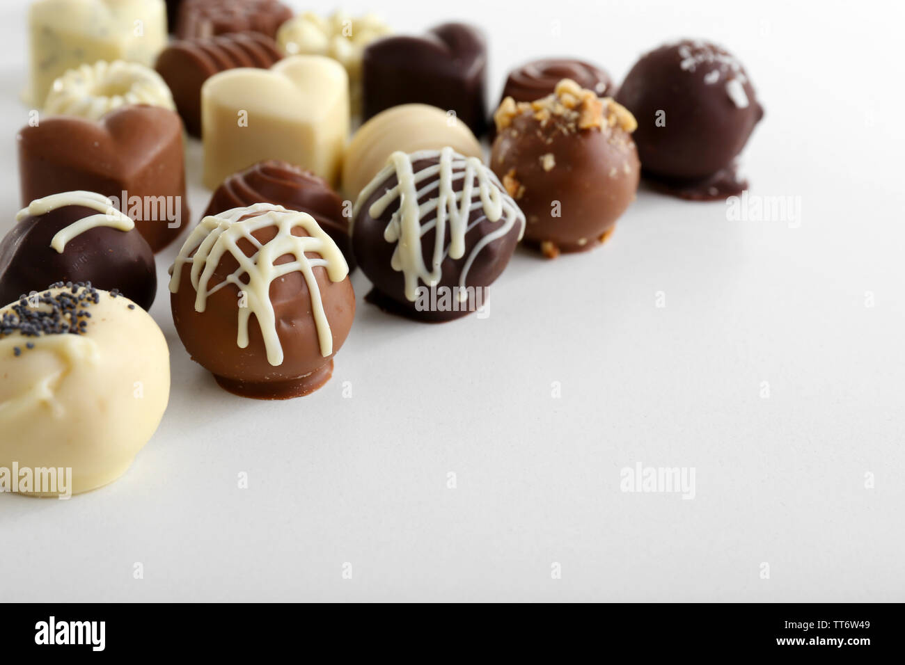 Delicious chocolate candies isolated on white Stock Photo - Alamy