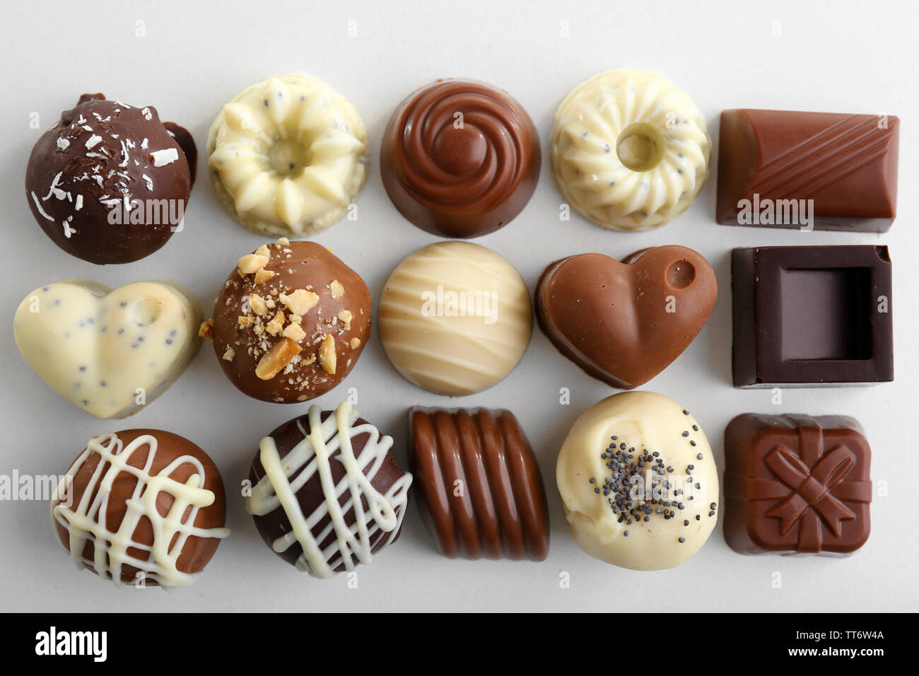 Delicious chocolate candies isolated on white Stock Photo - Alamy
