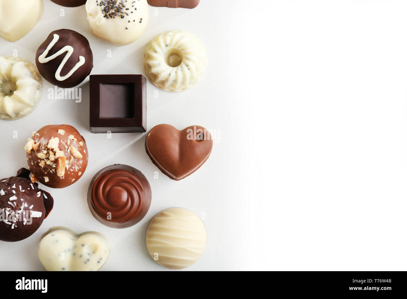 Delicious chocolate candies isolated on white Stock Photo - Alamy