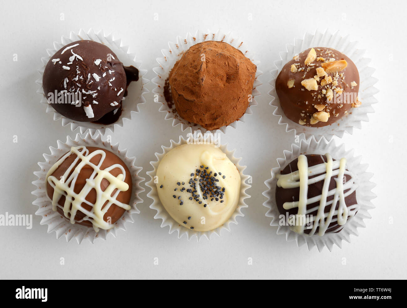 Delicious chocolate candies isolated on white Stock Photo - Alamy