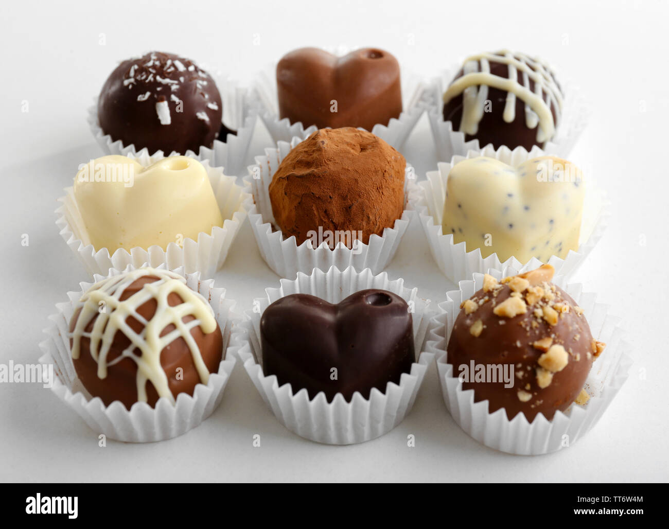 Delicious chocolate candies isolated on white Stock Photo - Alamy