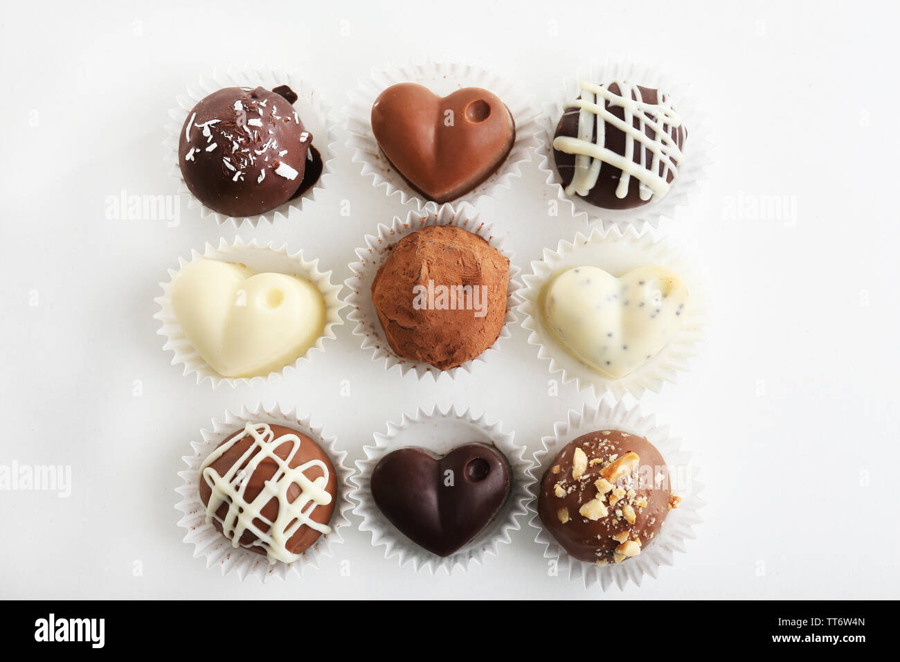 Delicious chocolate candies isolated on white Stock Photo - Alamy