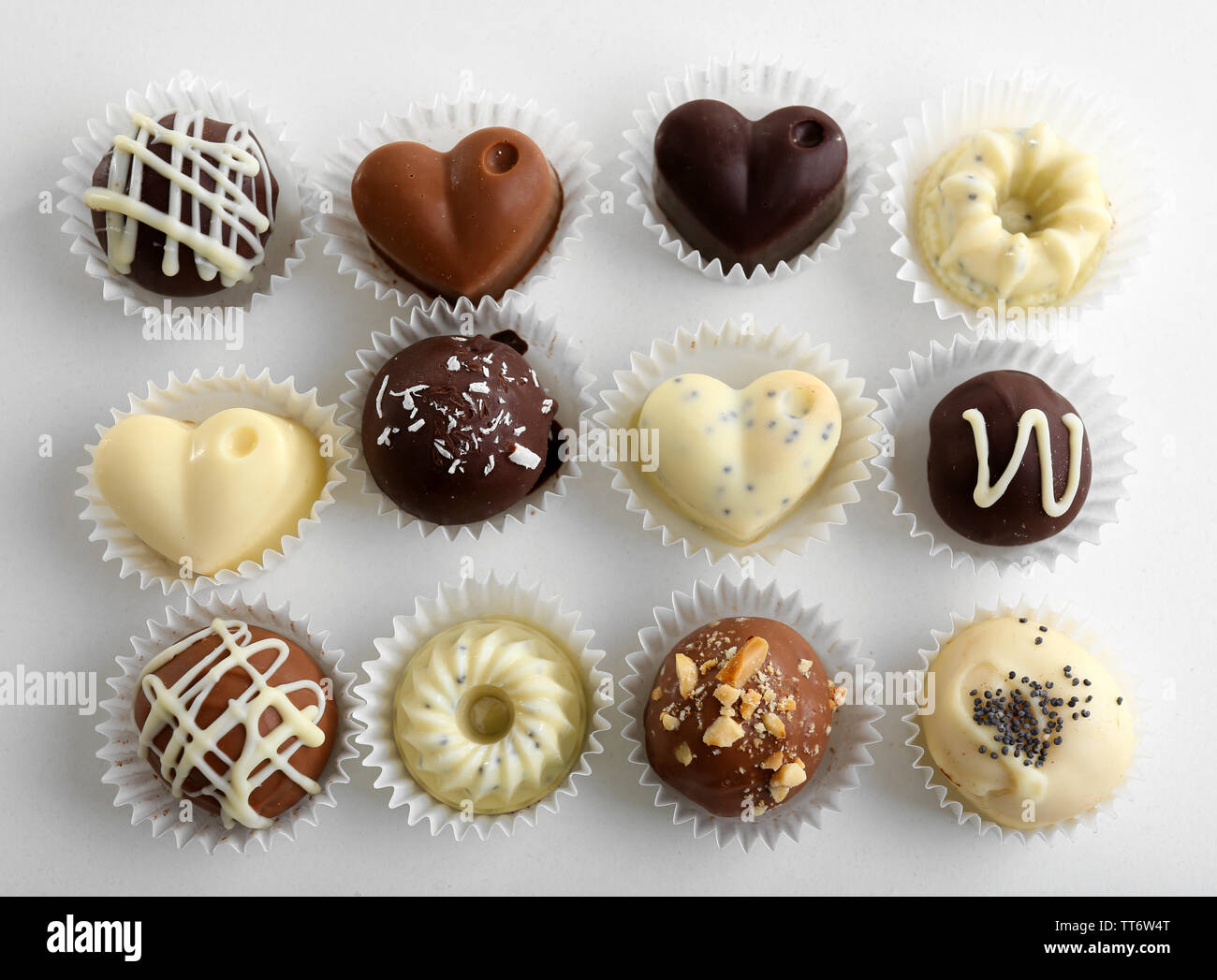 Delicious chocolate candies isolated on white Stock Photo - Alamy