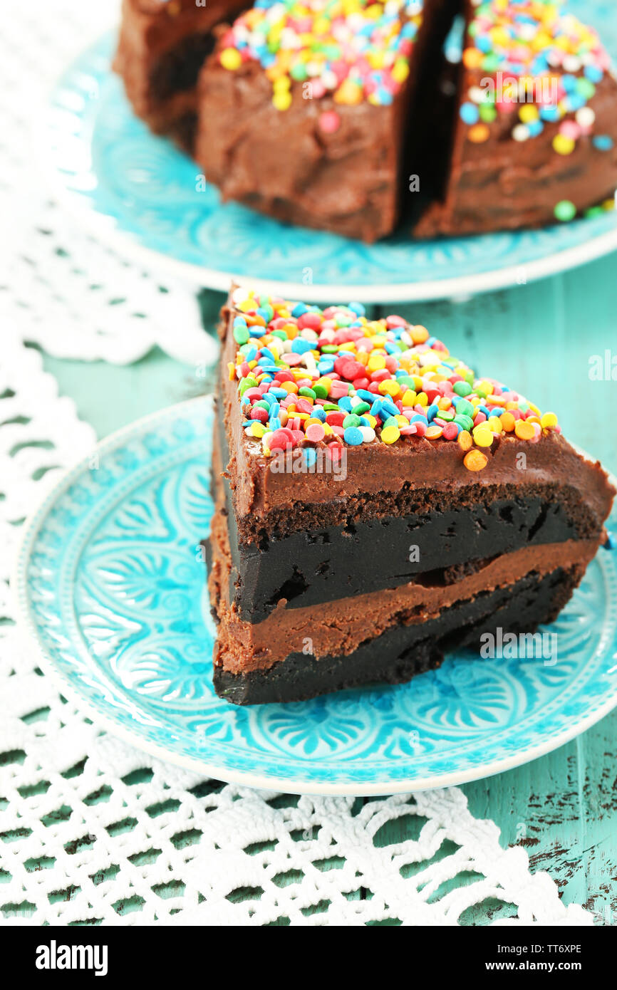 Chocolate cake with colorful sweet powder on table close-up Stock Photo ...