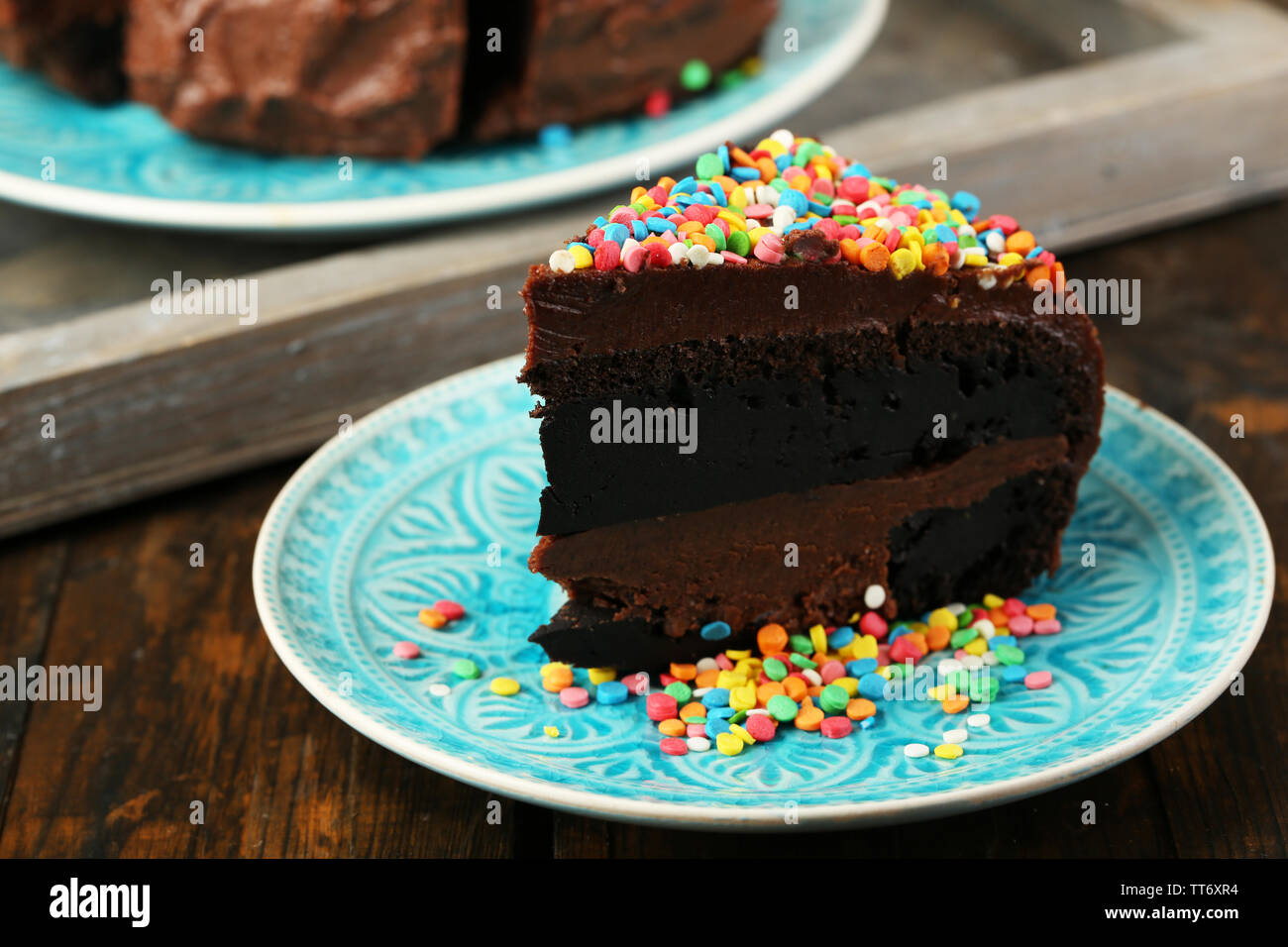 Chocolate cake with colorful sweet powder on table close-up Stock Photo ...